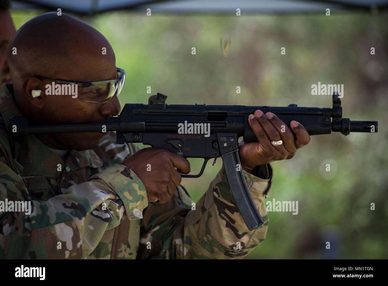 Chief Master Sergeant of the Air Force Kaleth O. Wright fires a weapon ...