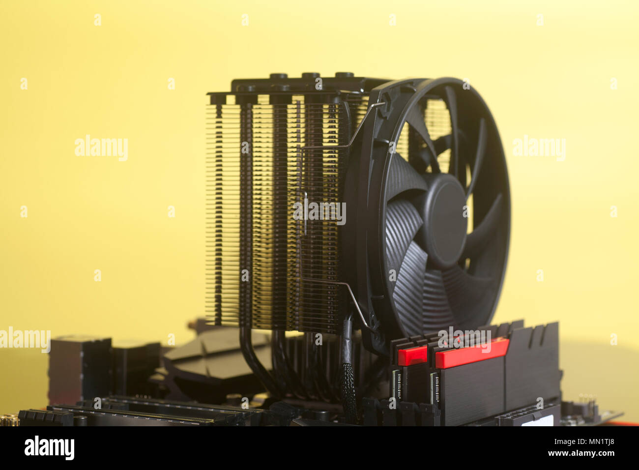 Motherboard computer circuit with CPU fan processor cooler on yellow ...