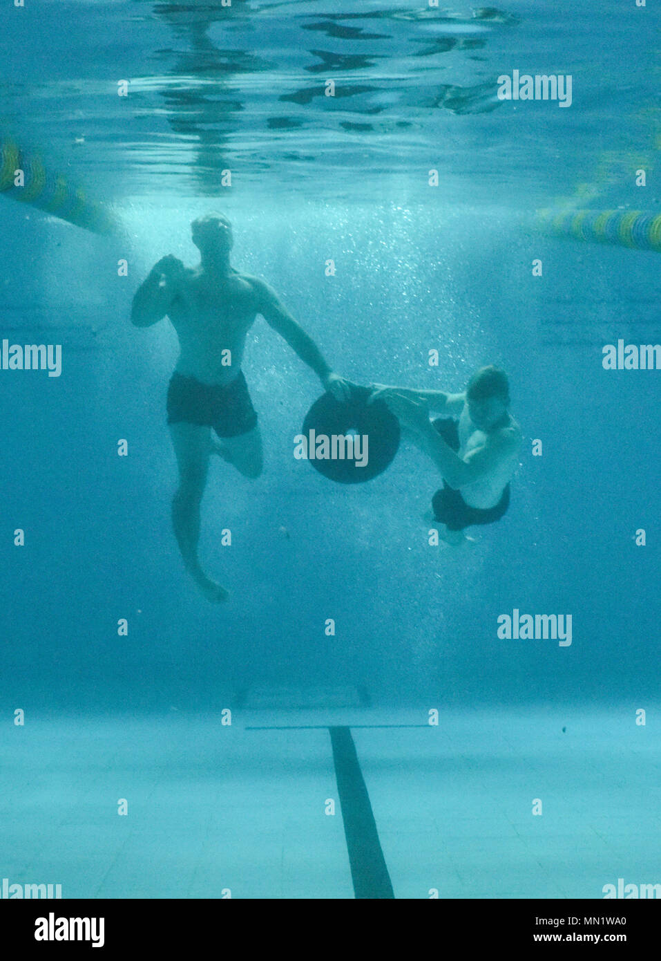 U.S. military members complete an underwater obstacle swim assessment ...