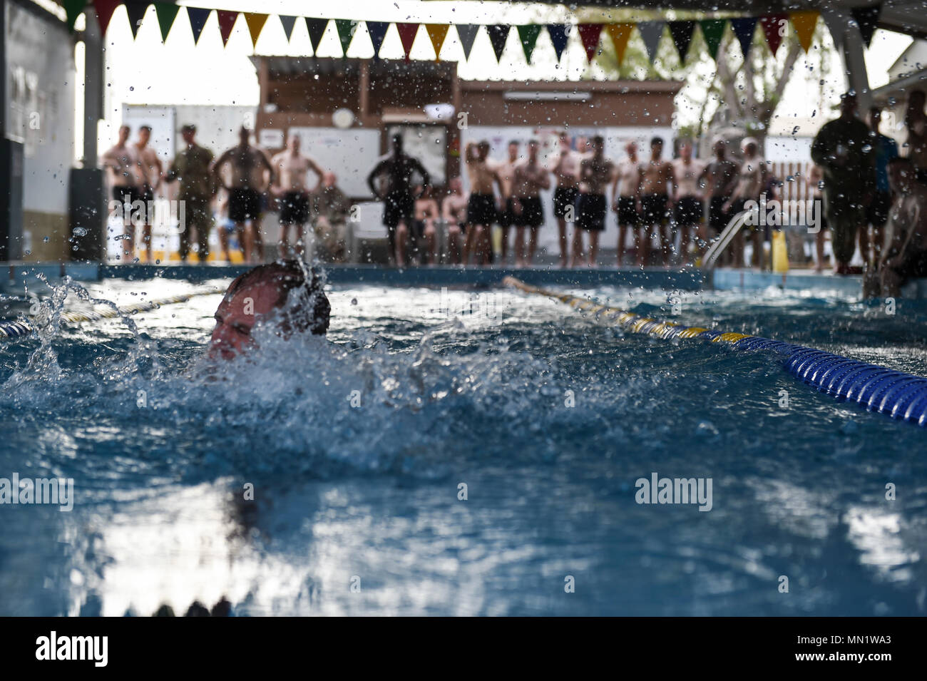A U.S. service member completes a 50-meter timed swim assessment during ...