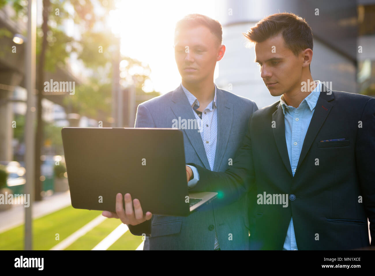 Two young handsome businessmen working together outside the buil Stock ...