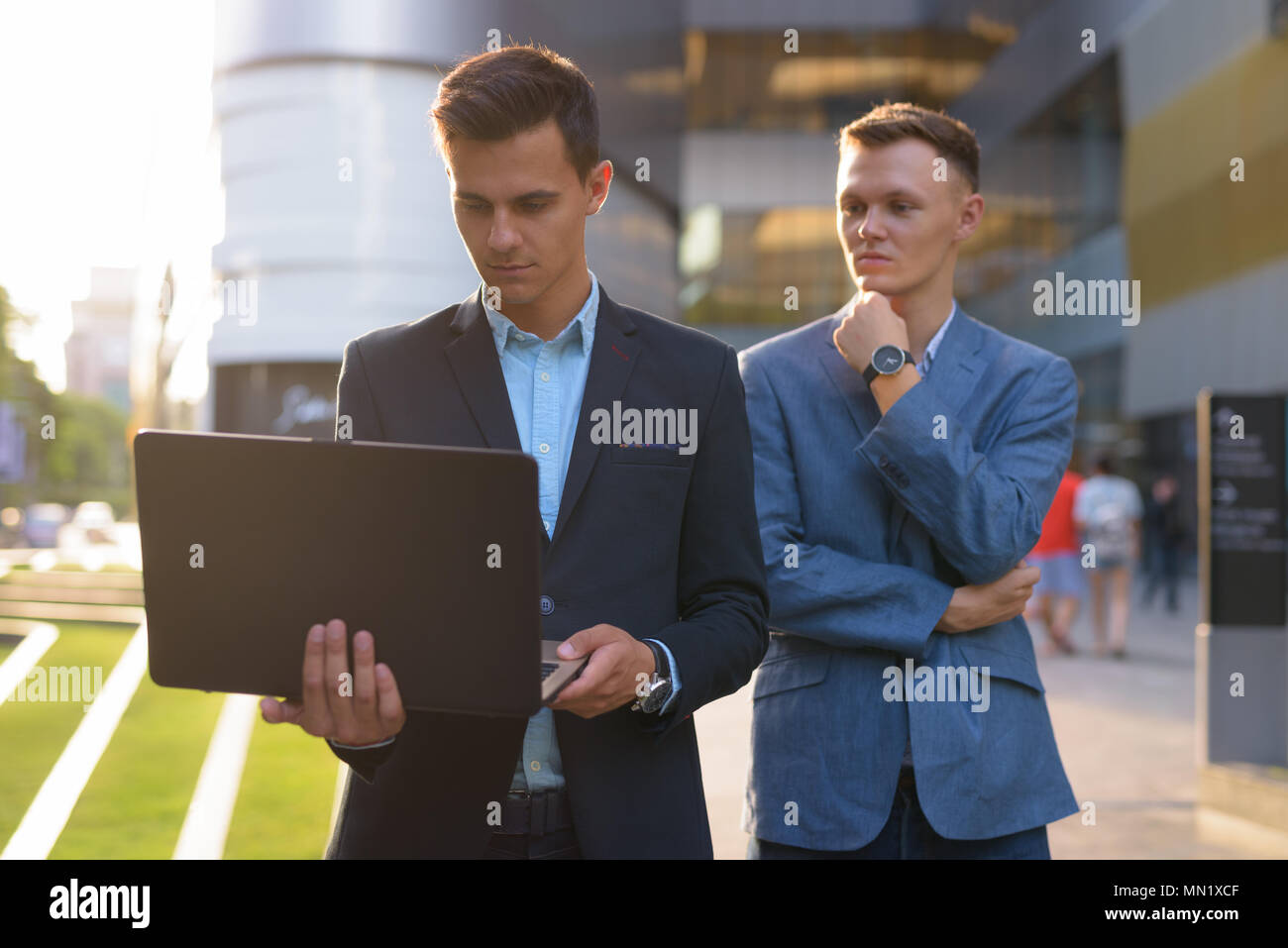 Two young handsome businessmen working together outside the buil Stock ...