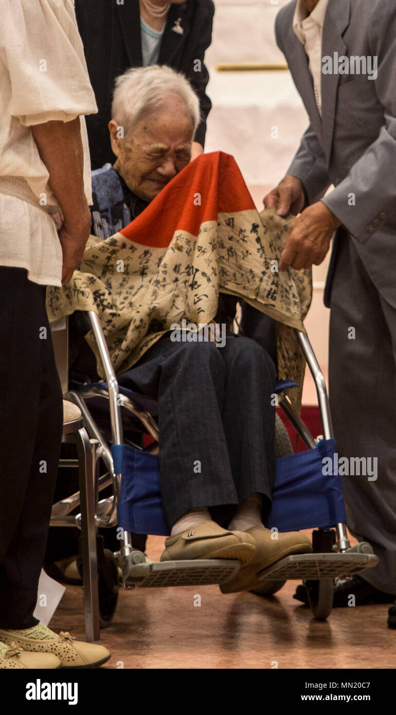 Sayoko Furuta mourns over her brother’s flag at Higashishirakawa ...