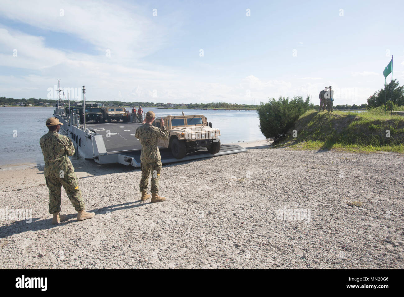 Marines offload a high mobility wheeled vehicle from a naval landing ...