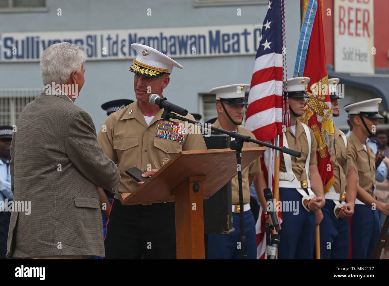Graeme Day hands a military-issue pocket Bible to Maj. Gen. Eric M ...