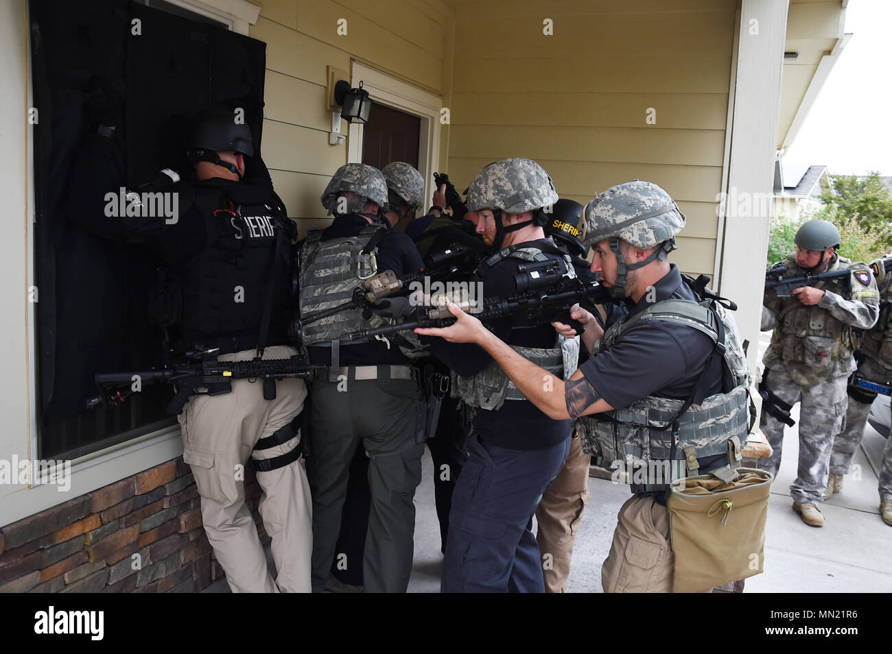 El Paso County SWAT Team trainees practice barricading the window of a ...