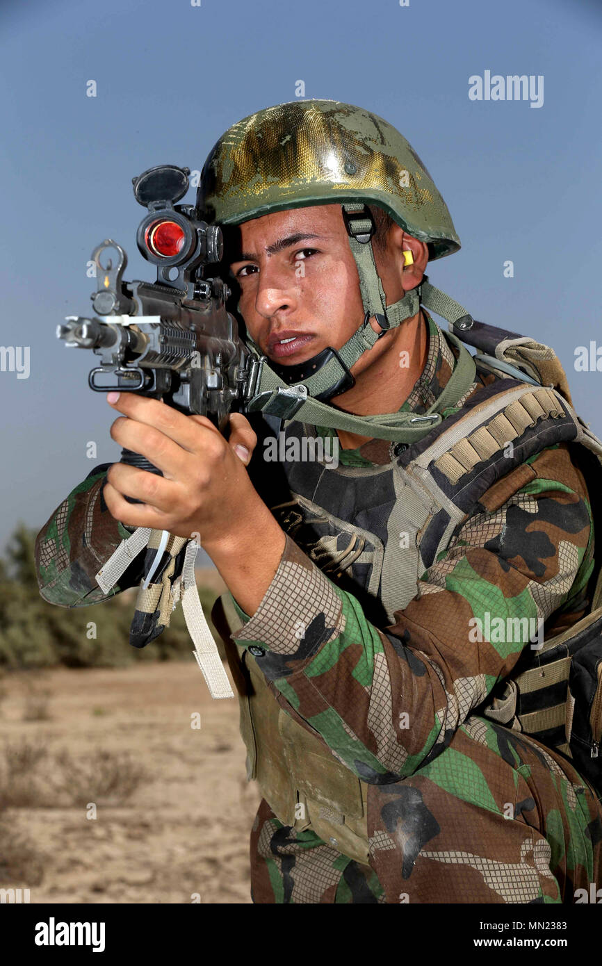 An Iraqi army ranger aims down the sights of his weapon system during ...