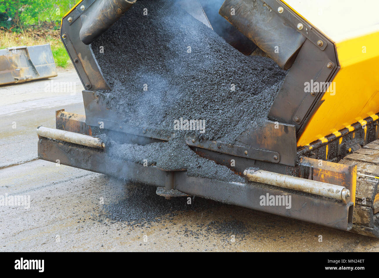 Asphalt with shovels at road and the asphalting machines Stock Photo ...