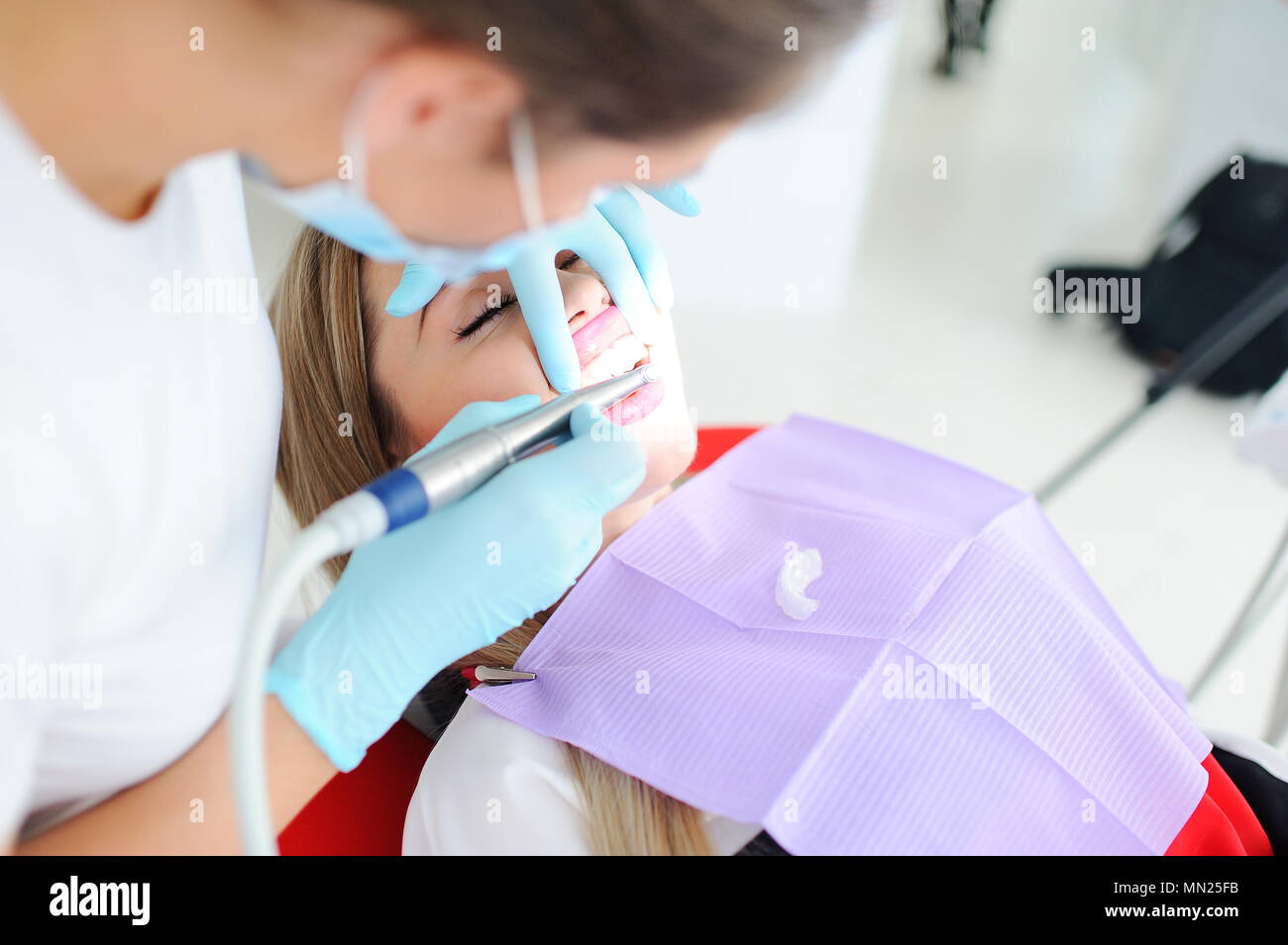 The dentist is treating the teeth to the patient Stock Photo - Alamy