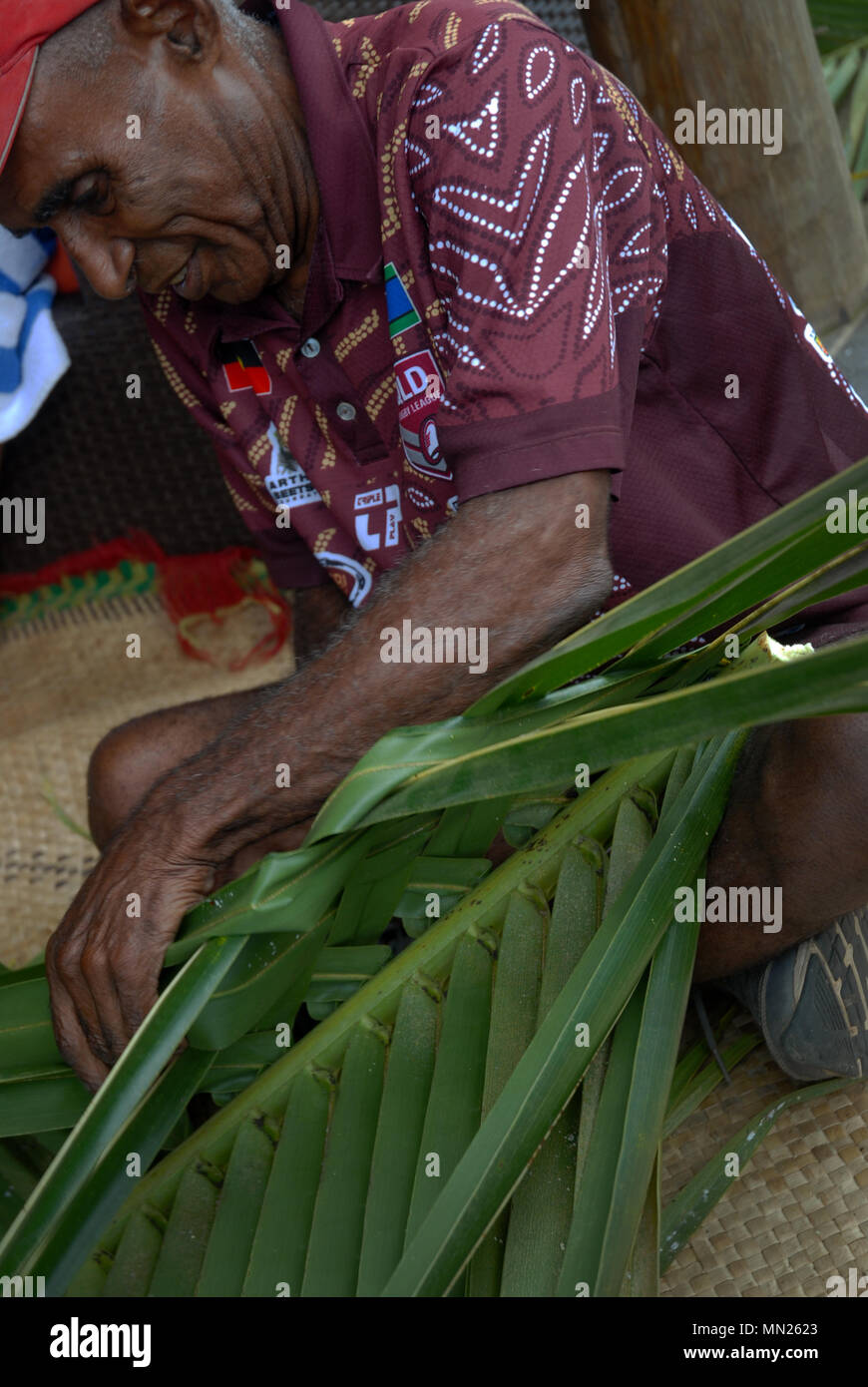 Fijian man creates a basket from weaving a Coconut Palm leaves, Pacific ...