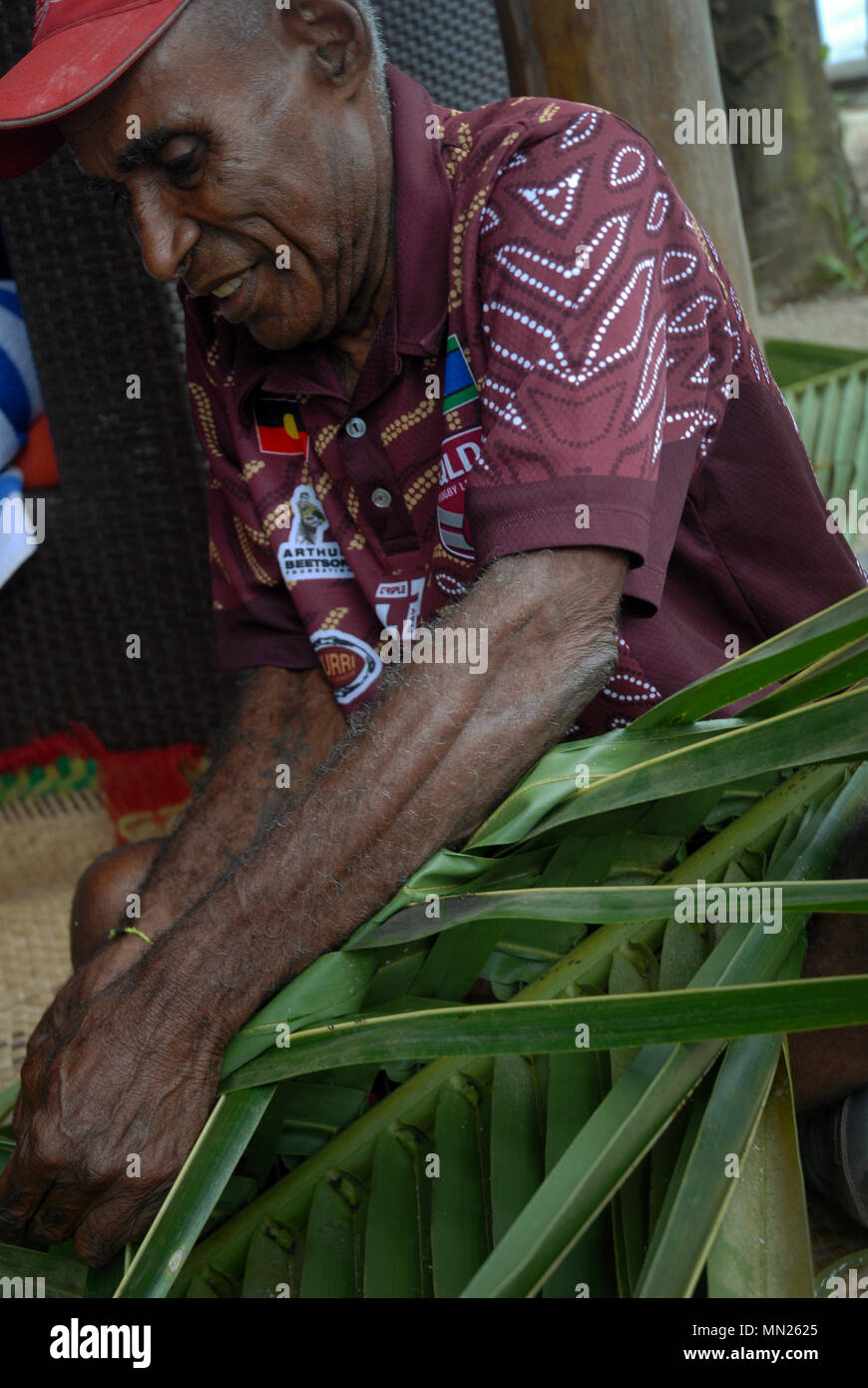 Fijian man creates a basket from weaving a Coconut Palm leaves, Pacific ...