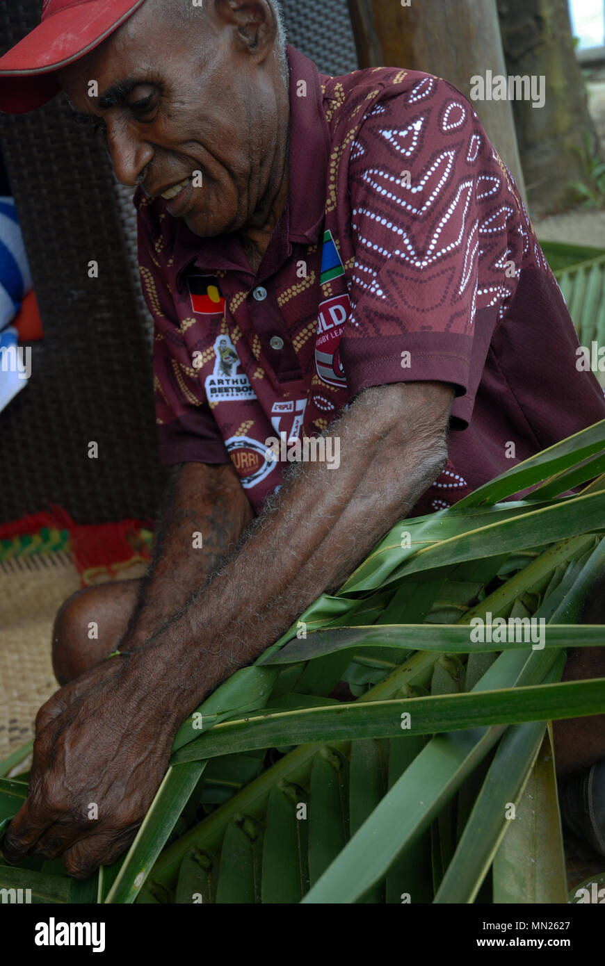 Fijian man creates a basket from weaving a Coconut Palm leaves, Pacific ...