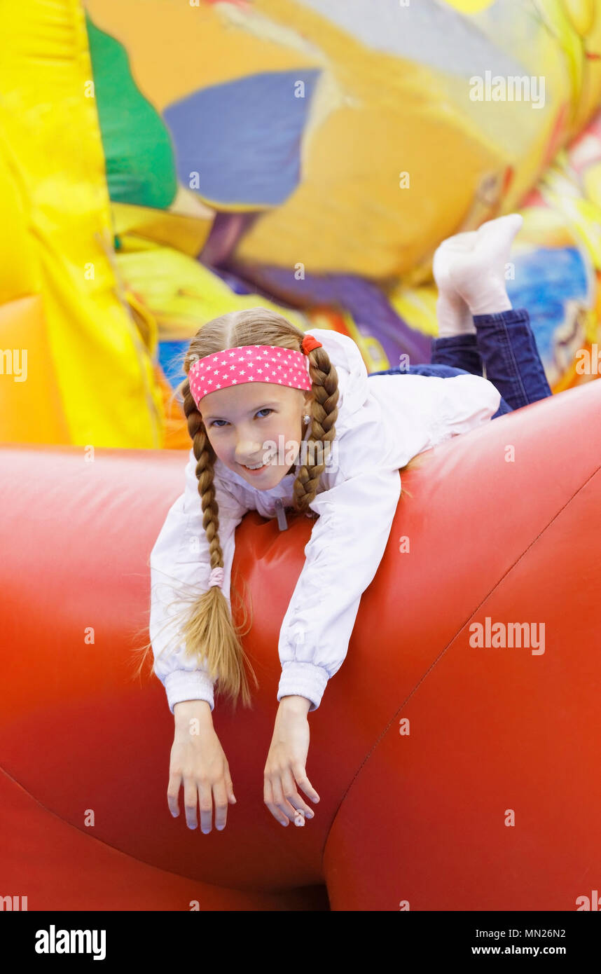 Girl have fun in the park on an inflatable attraction Stock Photo - Alamy