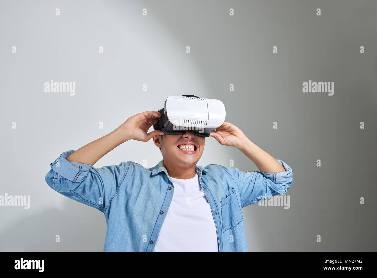 Asian young man wearing virtual reality headset Stock Photo - Alamy