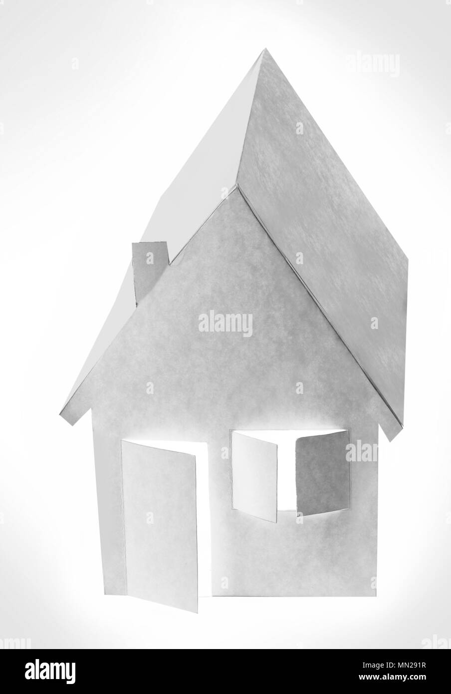 Paper house on a white background with backlight on the window and ...