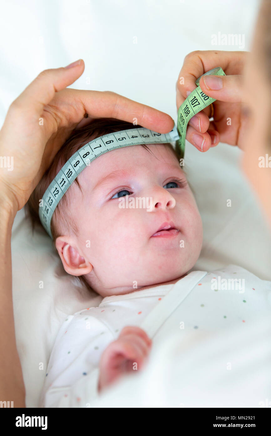 Baby is being measured by mother, doctor, woman Stock Photo - Alamy