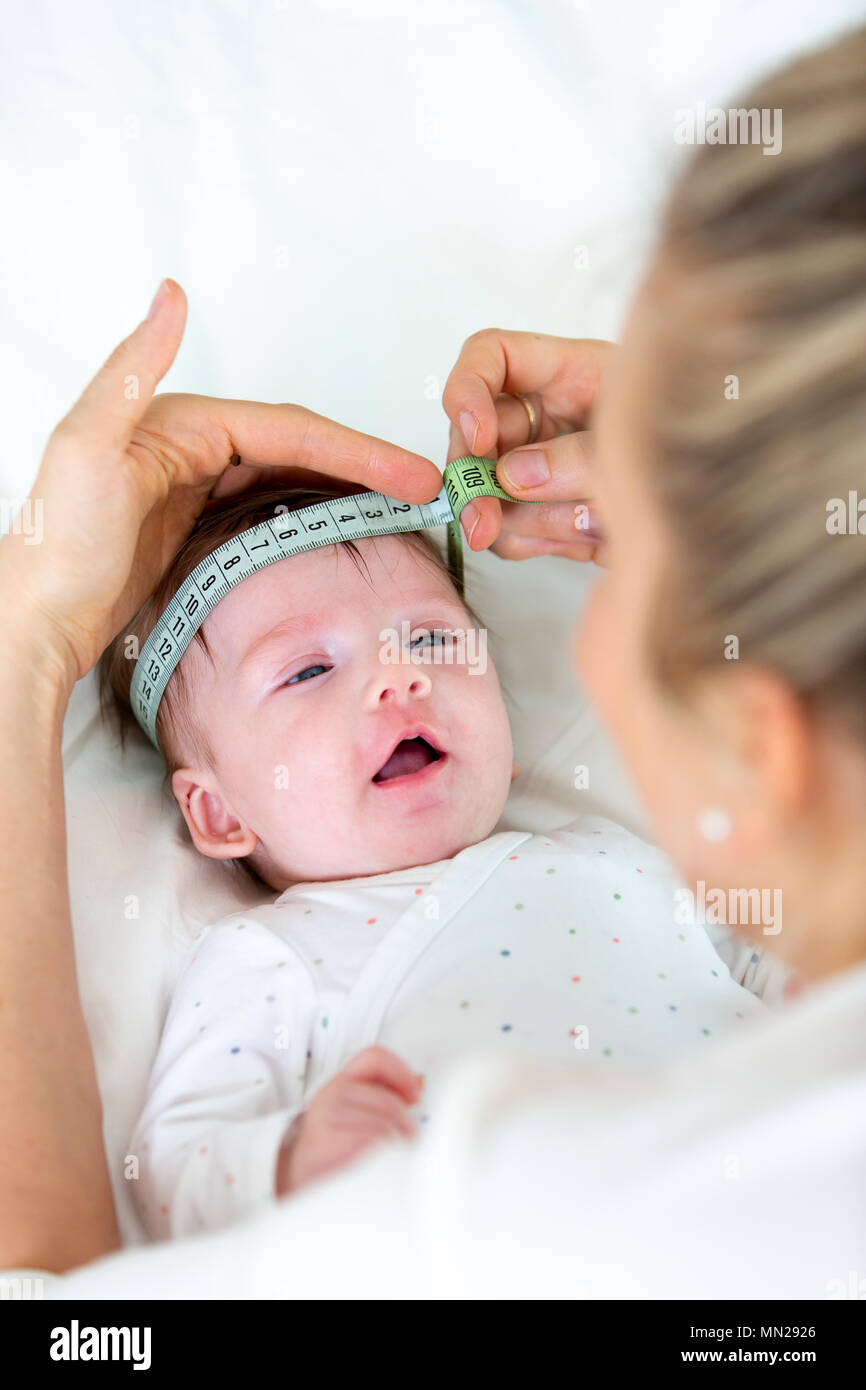 Baby is being measured by mother, doctor, woman Stock Photo - Alamy