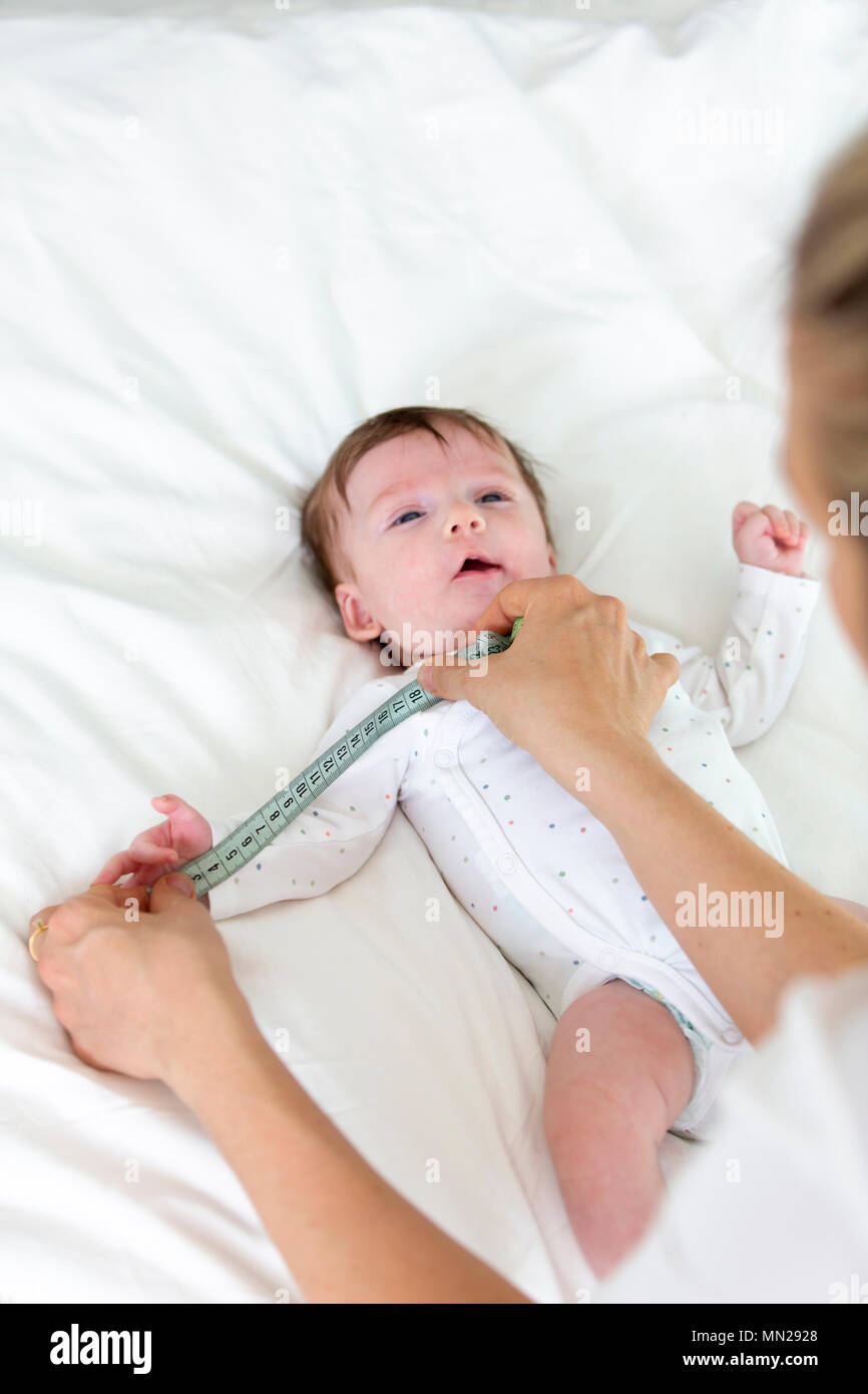 Baby is being measured by mother, doctor, woman Stock Photo - Alamy