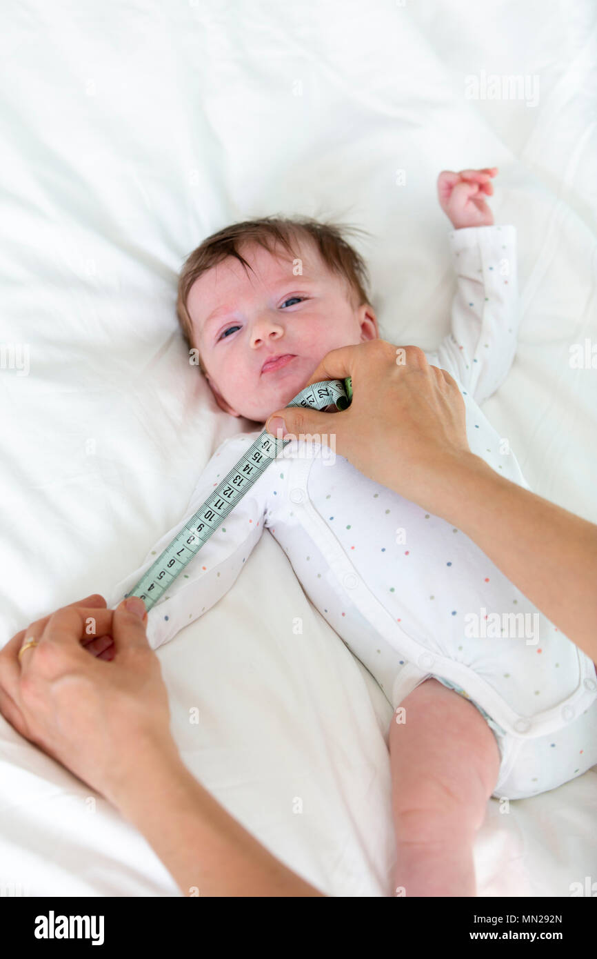 Baby is being measured by mother, doctor, woman Stock Photo - Alamy