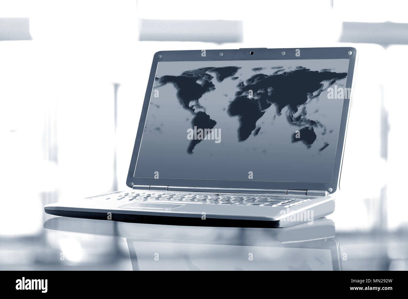 Laptop with a map of the world Stock Photo - Alamy
