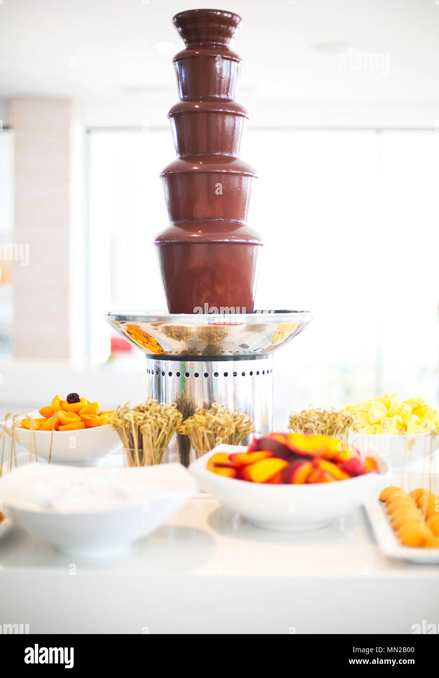 Chocolate fondue with fruits on the table Stock Photo - Alamy