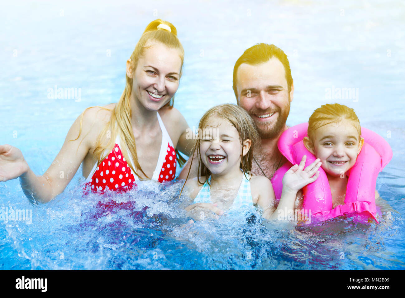 Family relaxing swimming pool hi-res stock photography and images - Alamy