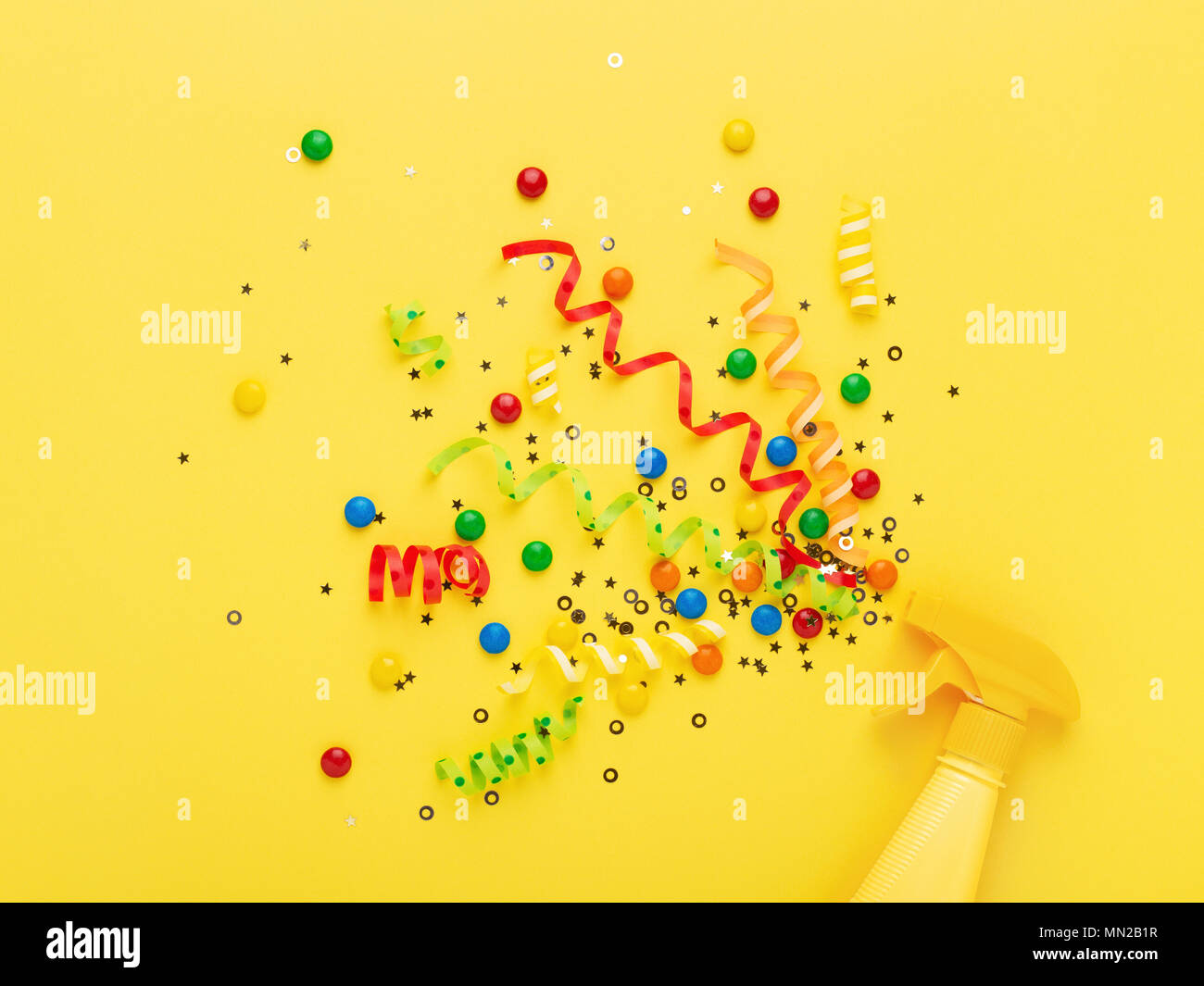 Party spray on yellow background. Bright creative background with ...