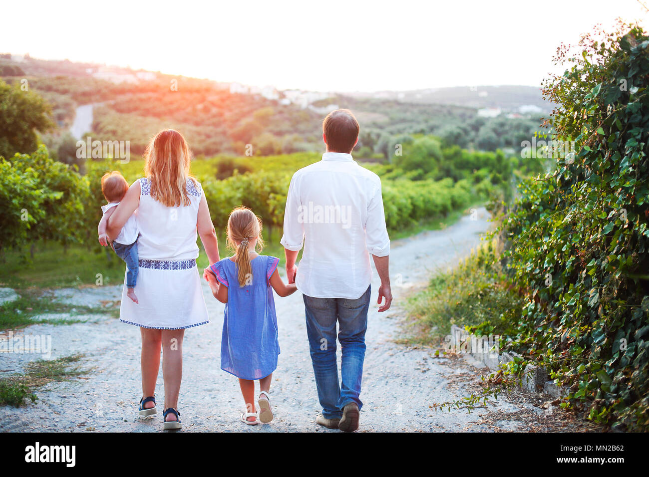 Family outdoors on sunset back view. Concept Stock Photo - Alamy