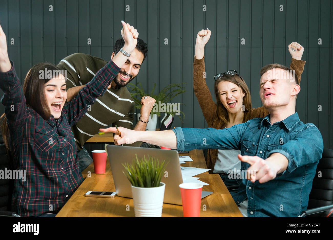 Thrilling reaction of it team to great success, four young workers ...