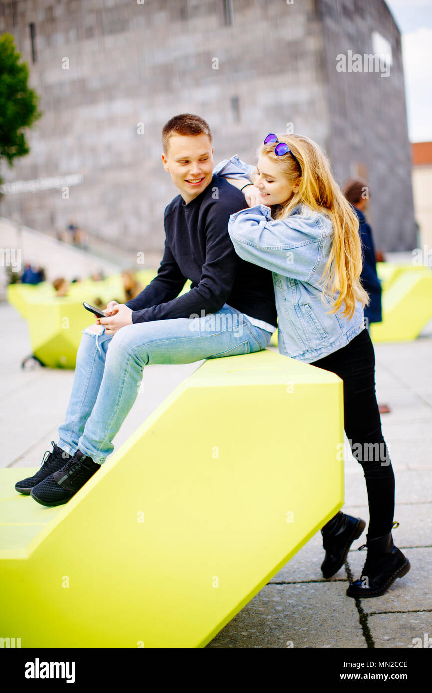 Young people sitting on the modern bench on street in Vienna, Austria ...