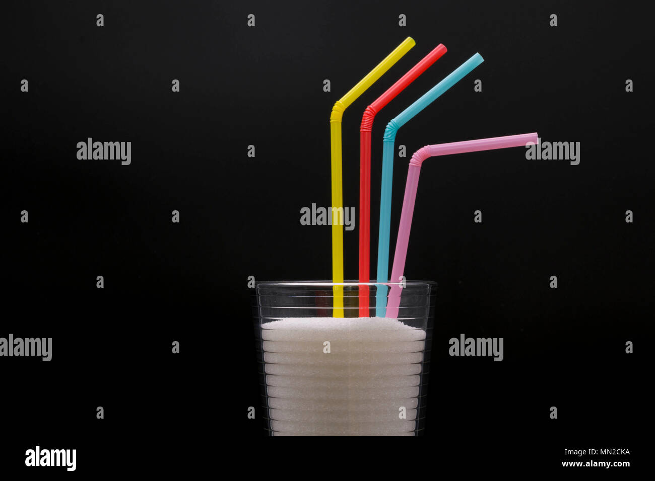 Sugar tax / levy in the uk depicted by a glass of sugar with drinking ...
