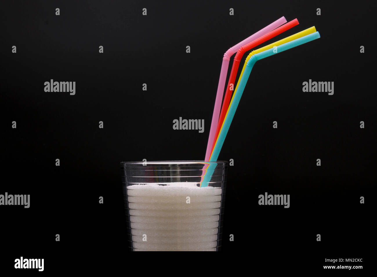 Sugar tax / levy in the uk depicted by a glass of sugar with drinking ...