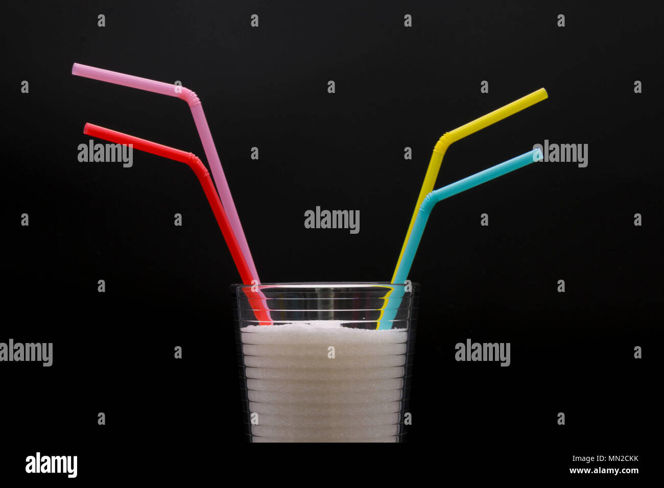 Sugar tax / levy in the uk depicted by a glass of sugar with drinking ...