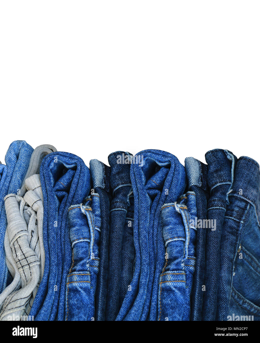 Stack of blue jeans on white background with copy space Stock Photo - Alamy