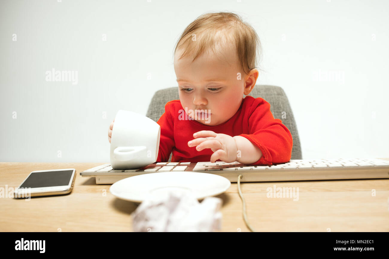 Happy child baby girl toddler sitting with keyboard of computer ...