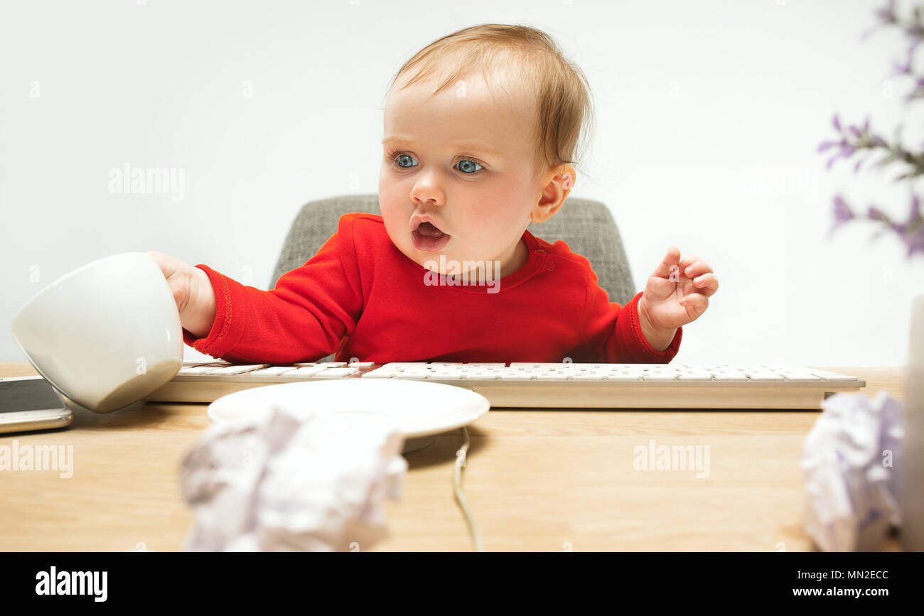Happy child baby girl toddler sitting with keyboard of computer ...