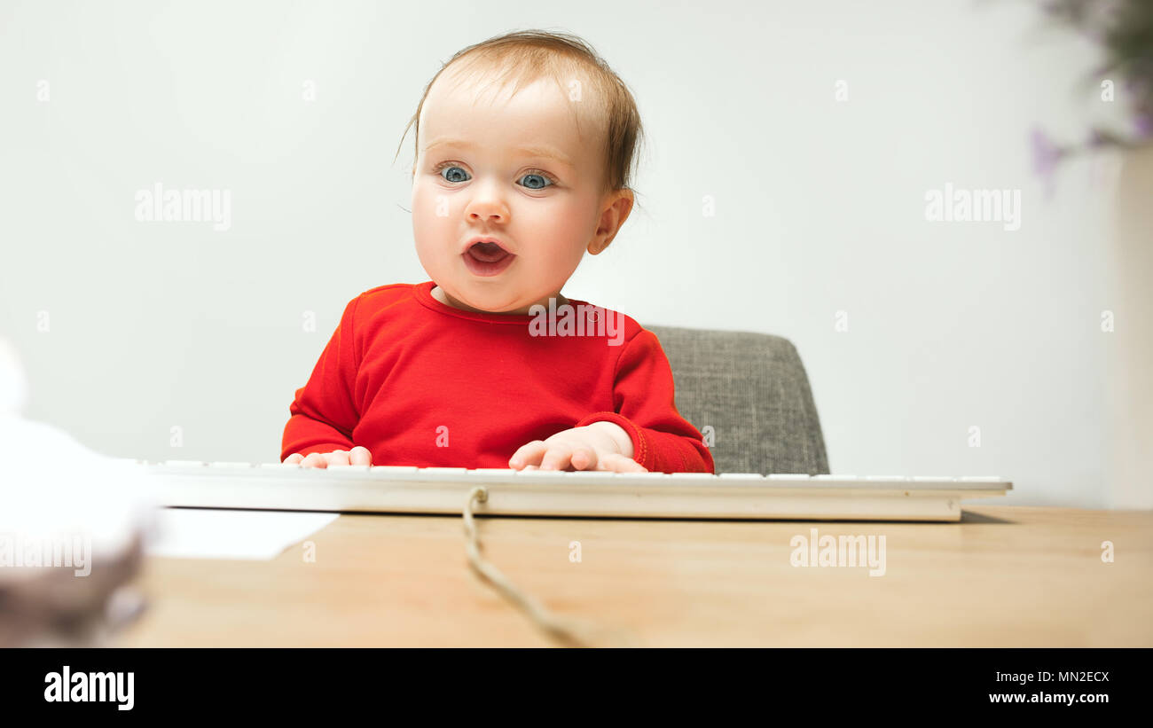 Happy child baby girl toddler sitting with keyboard of computer ...