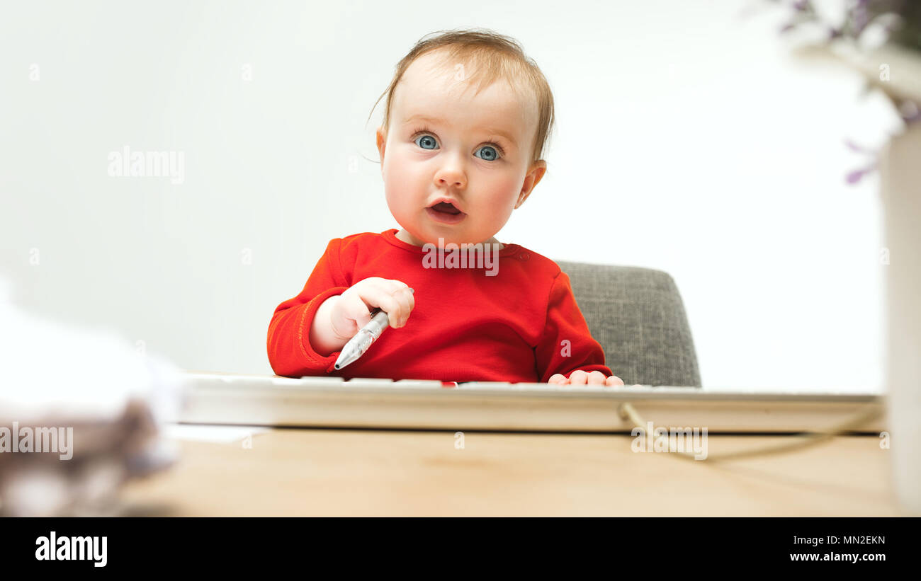 Happy child baby girl toddler sitting with keyboard of computer ...
