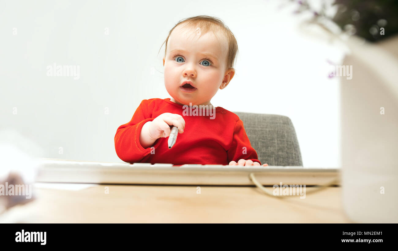Happy child baby girl toddler sitting with keyboard of computer ...