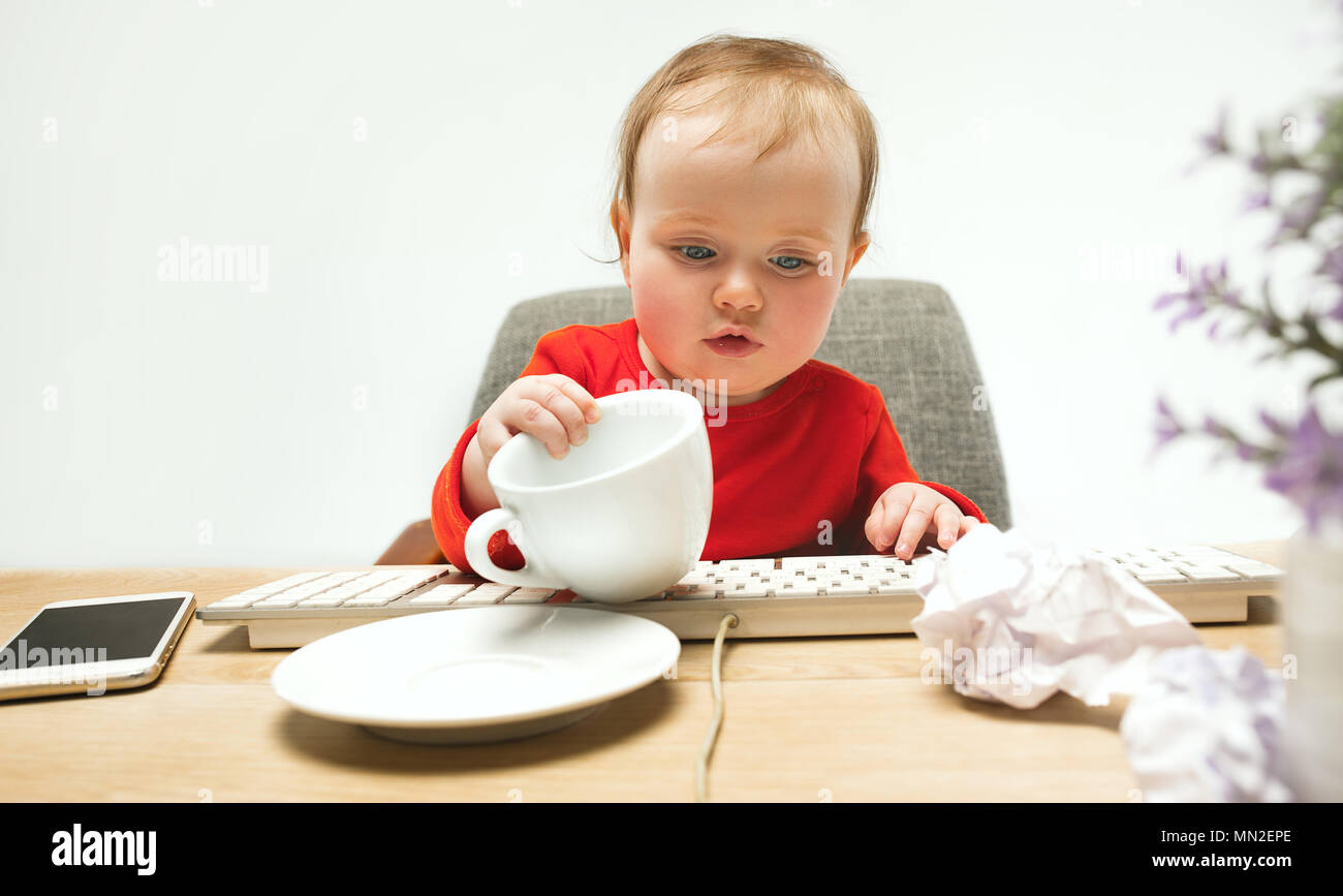 Happy child baby girl toddler sitting with keyboard of computer ...