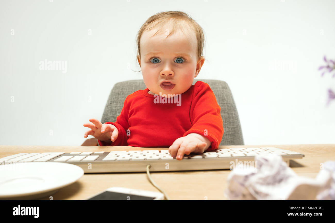 Happy child baby girl toddler sitting with keyboard of computer ...