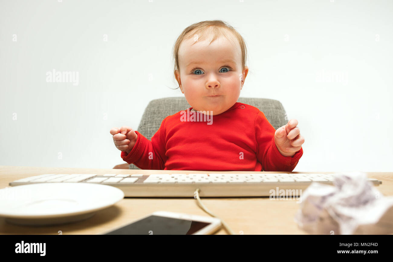 Happy child baby girl toddler sitting with keyboard of computer ...