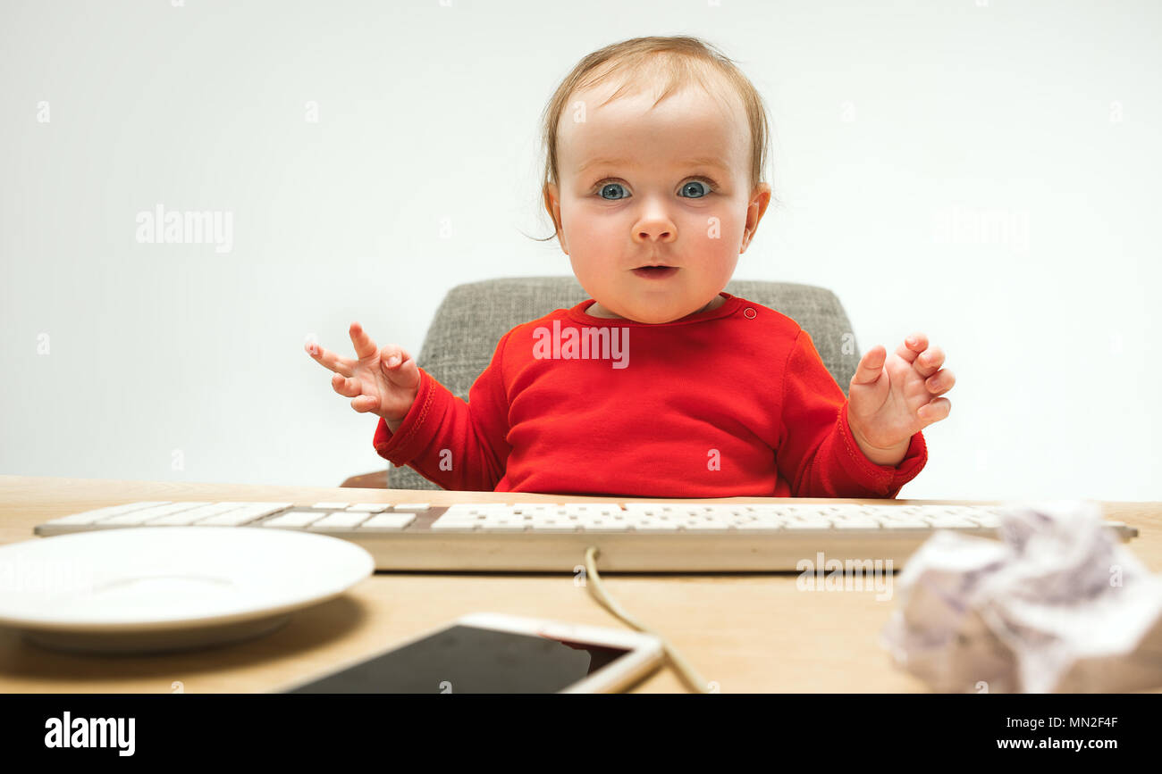 Happy child baby girl toddler sitting with keyboard of computer ...
