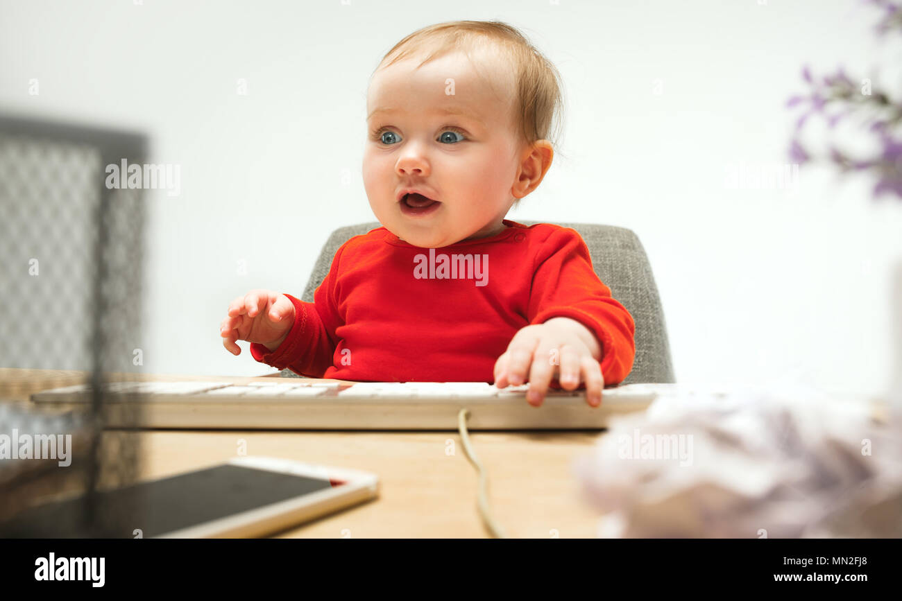 Happy child baby girl toddler sitting with keyboard of computer ...