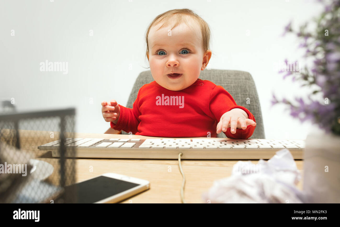 Happy child baby girl toddler sitting with keyboard of computer ...