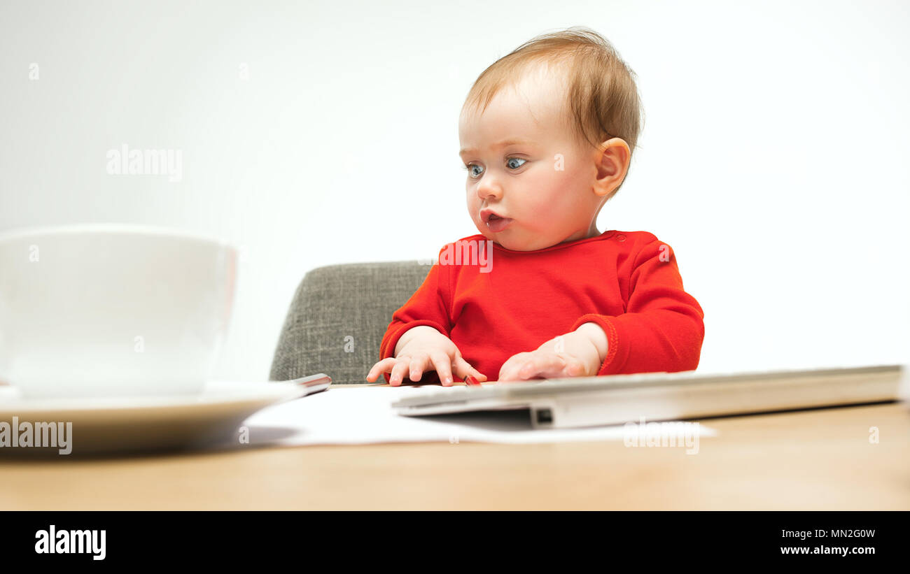 Happy child baby girl toddler sitting with keyboard of computer ...