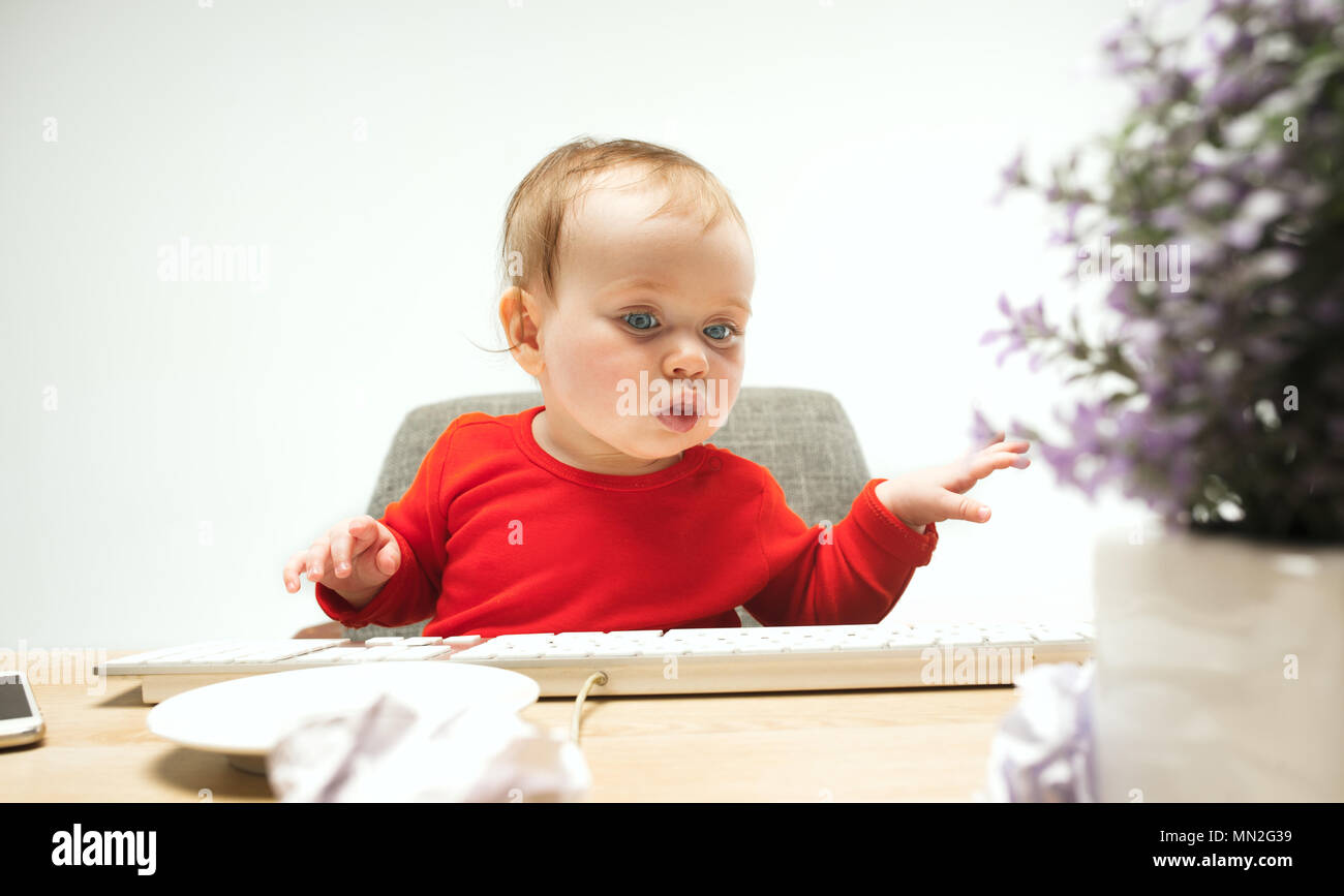 Happy child baby girl toddler sitting with keyboard of computer ...
