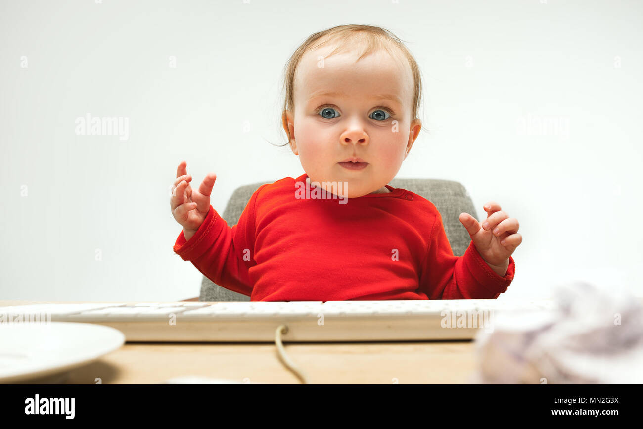Happy child baby girl toddler sitting with keyboard of computer ...