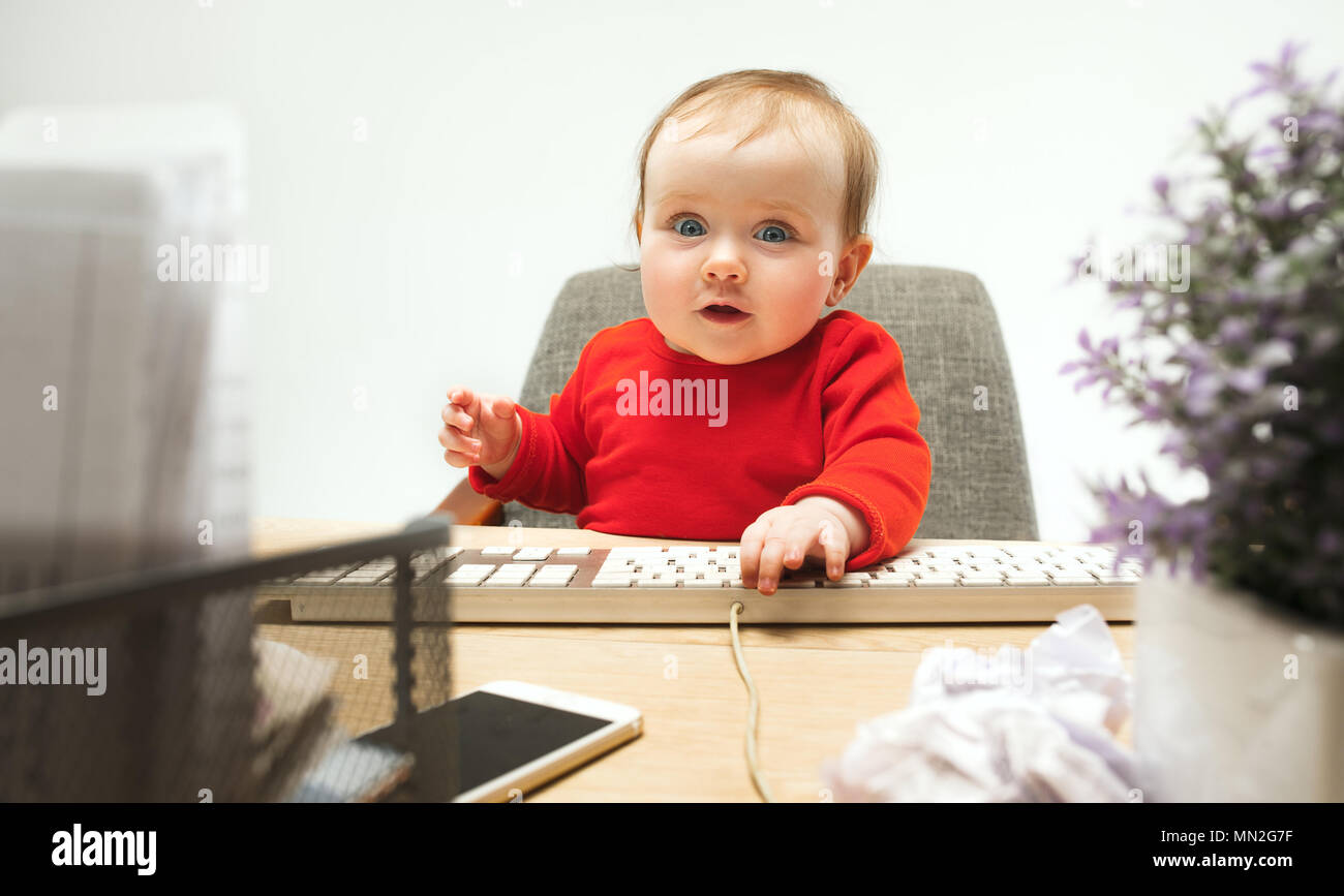 Happy child baby girl toddler sitting with keyboard of computer ...