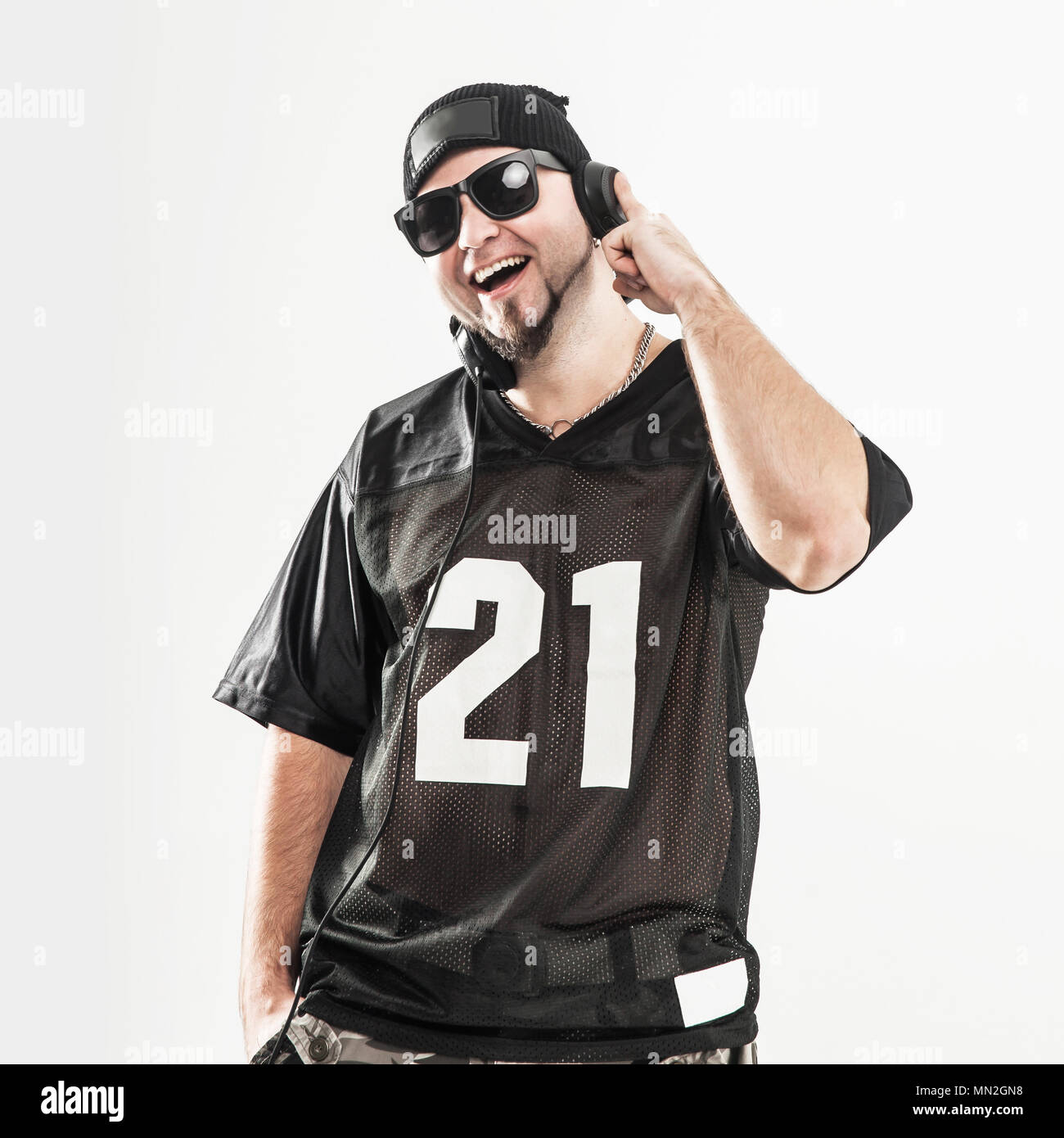 emotional and charismatic DJ - rapper with headphones on a light Stock ...